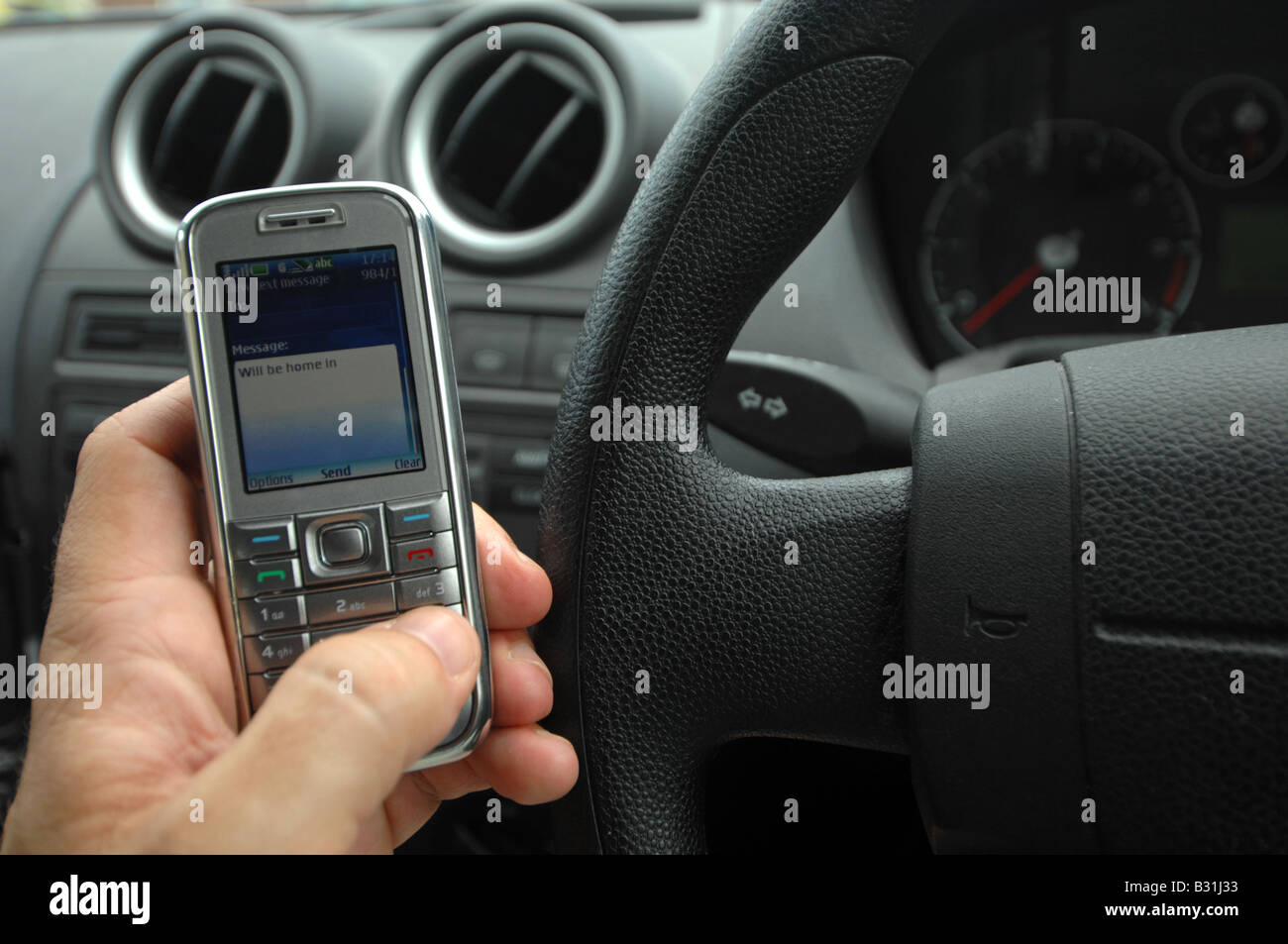 Texting and driving Stock Photo - Alamy