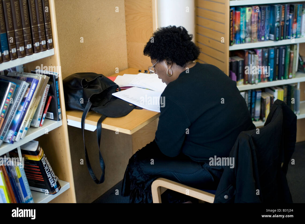 Studying in a public library Stock Photo - Alamy