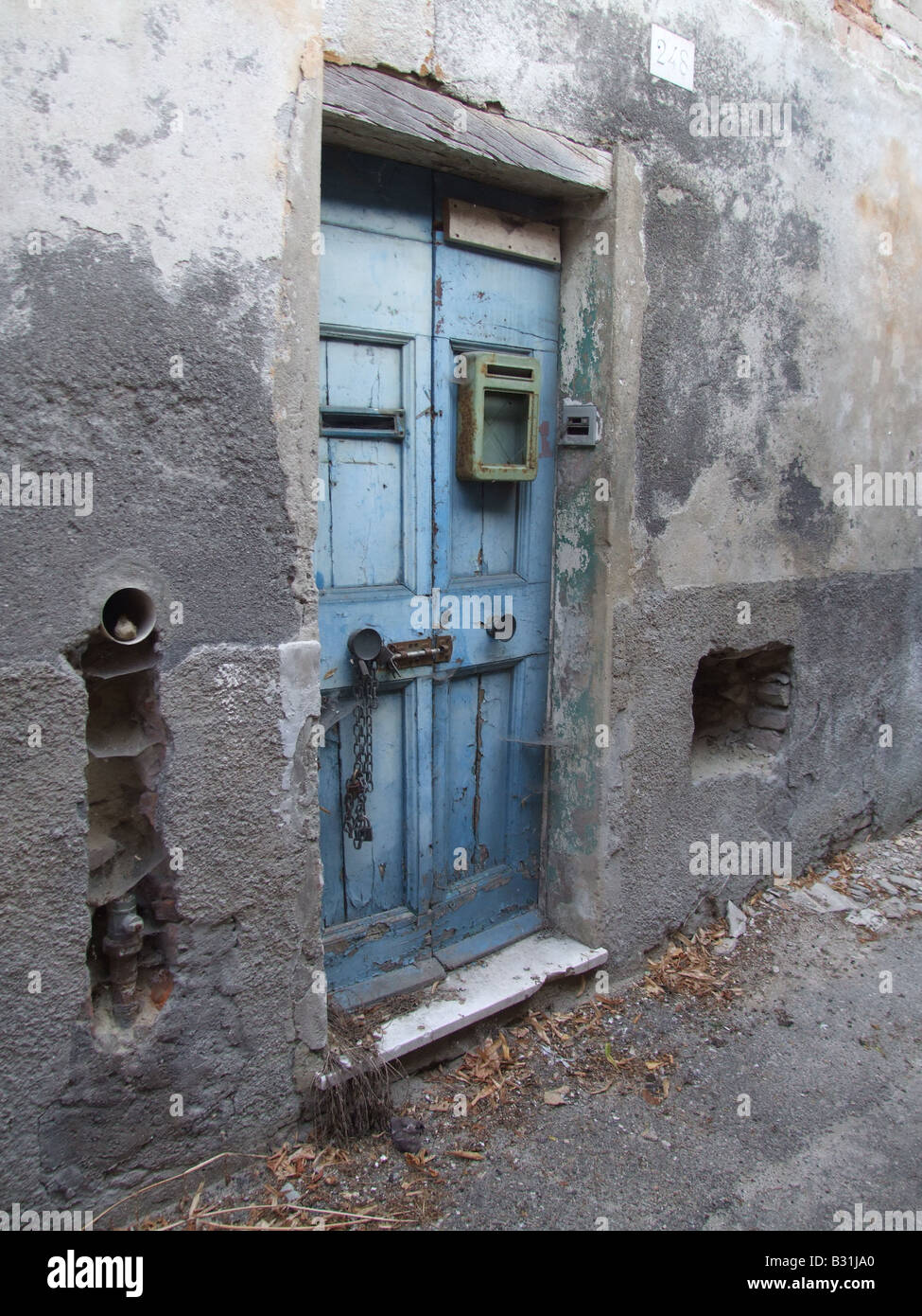 old damaged blue wooden door on home Stock Photo - Alamy