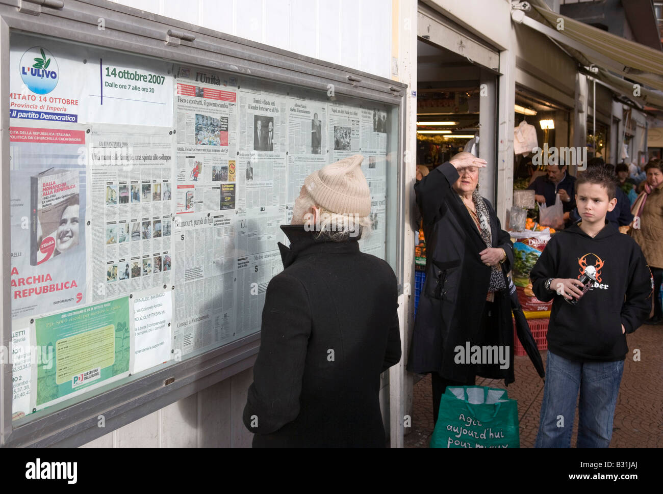 Man reading the leftist newspaper L Unita on display outside the ...