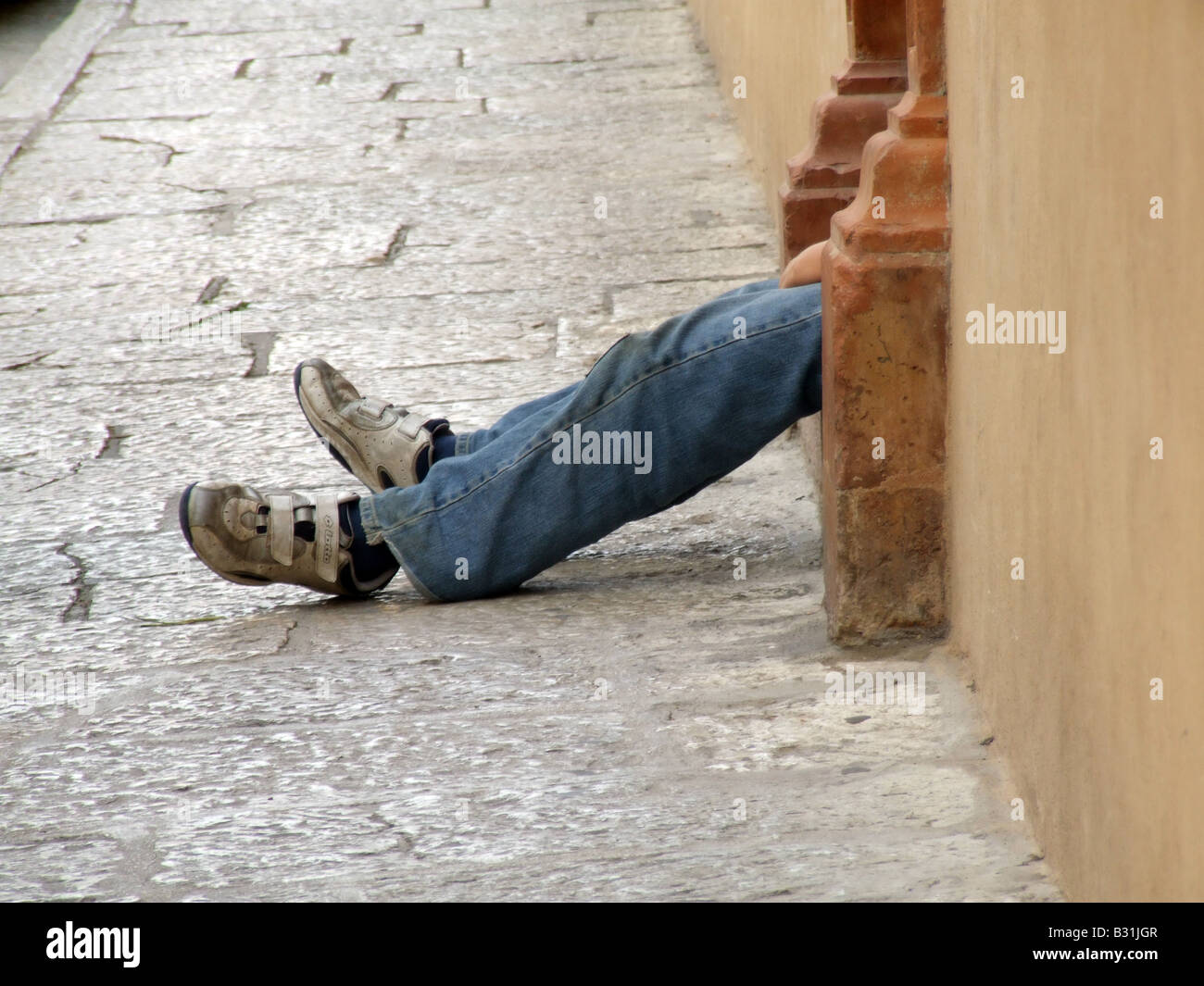 person sitting on steps on street outdoors Stock Photo - Alamy