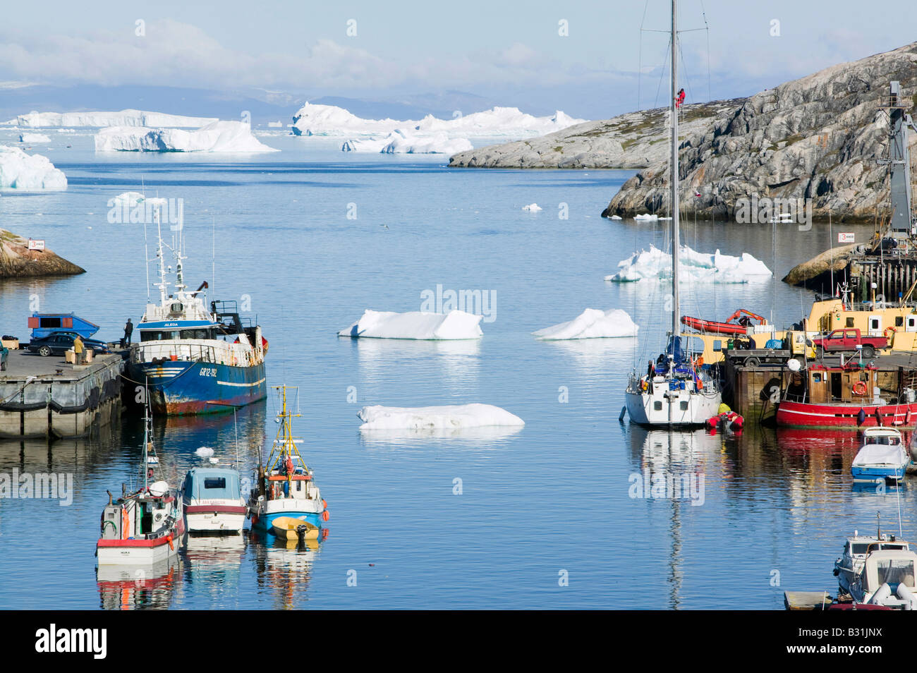 Inuit boats and icebergs in Illulissat harbour on Greenland Stock Photo ...