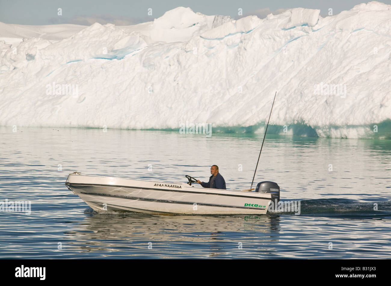 An Inuit fishing boat sails through Icebergs from the Jacobshavn ...