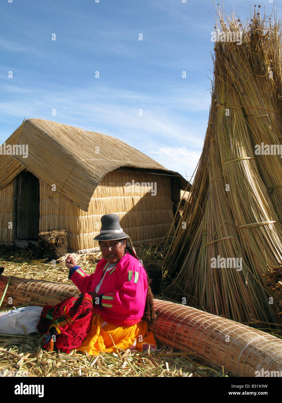 A Uros women weaving while living on self-fashioned floating reed ...