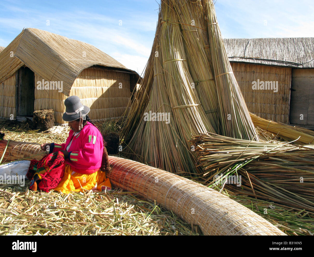 A Uros women weaving while living on self-fashioned floating reed ...