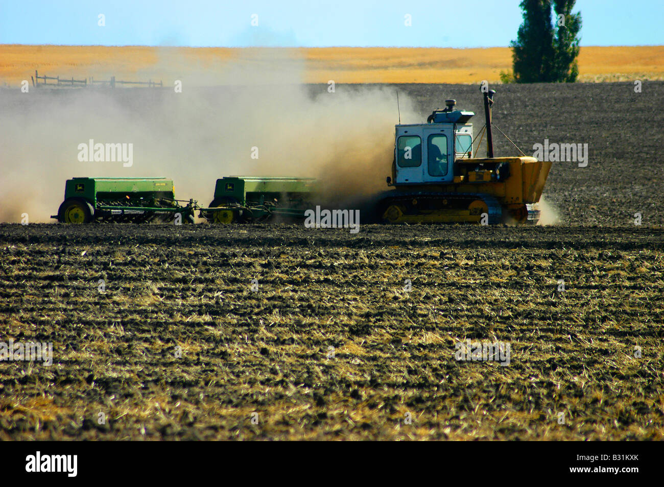 Tractor plowing a dusty field Stock Photo - Alamy
