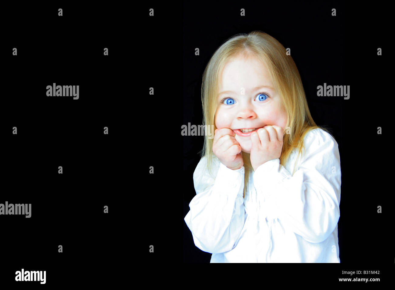 Cute little girl with a scared or surprised expression Stock Photo - Alamy