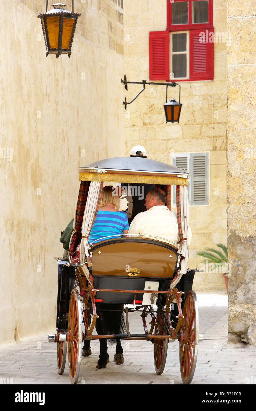 Karozzin (horse-drawn carriage) in typical narrow street, Mdina, Malta ...