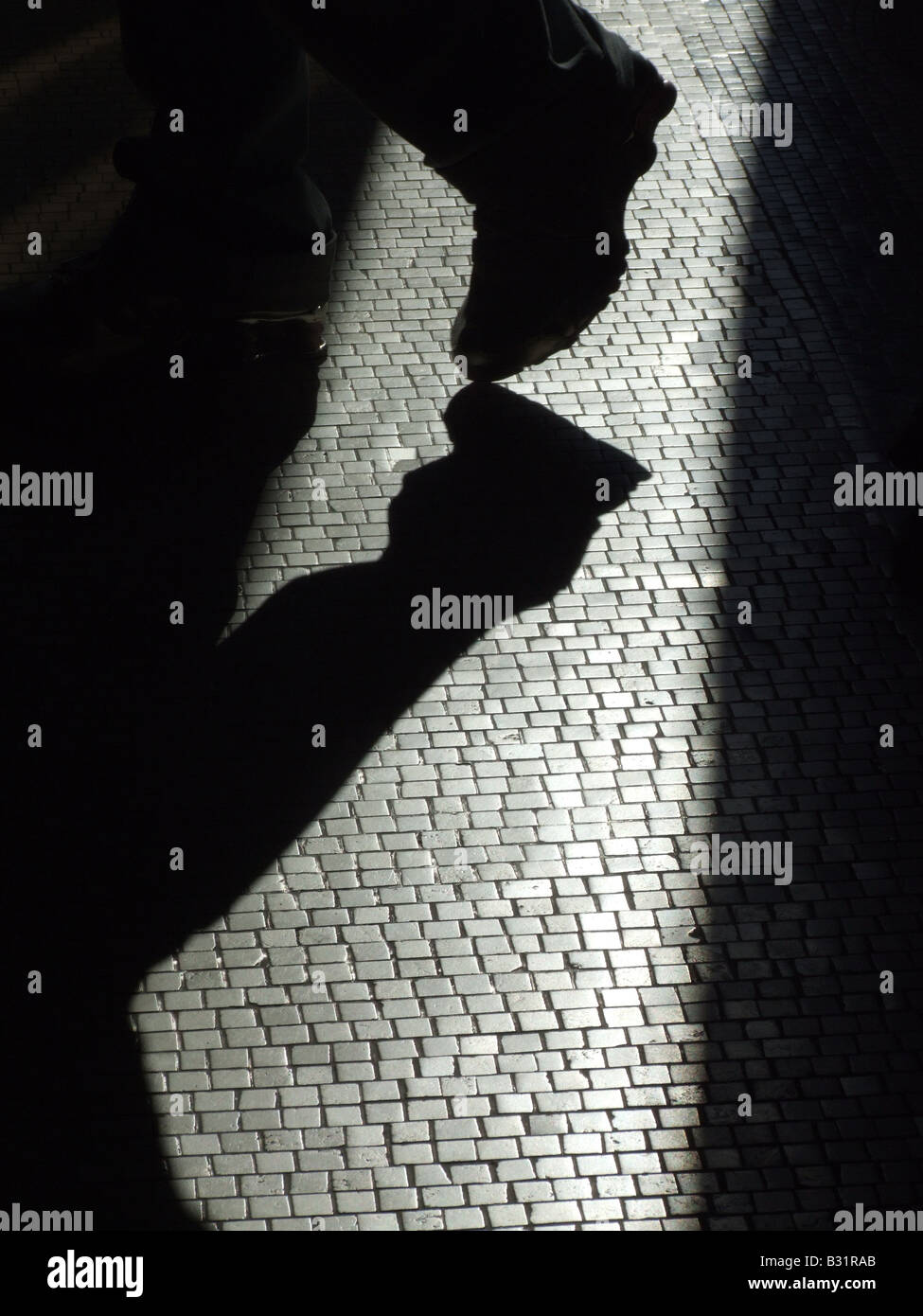 person walking through beam of light Stock Photo - Alamy