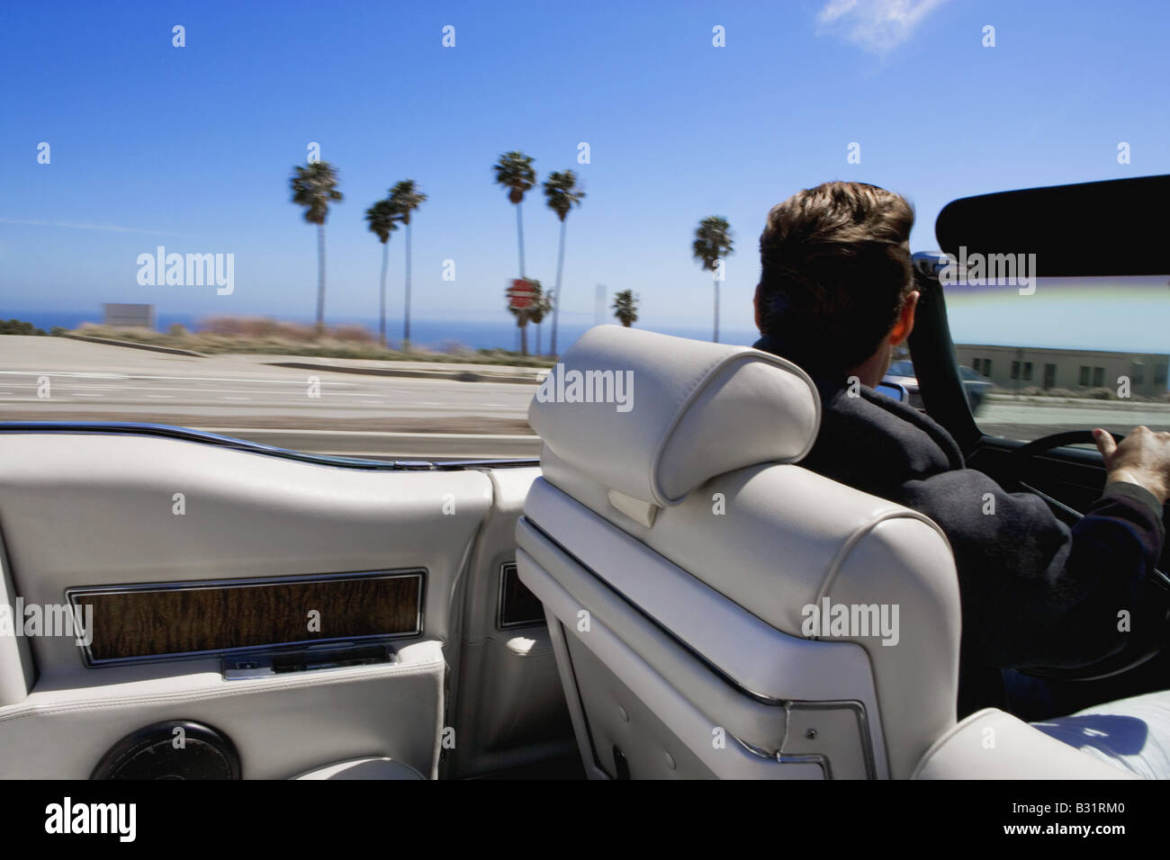 Man driving convertible along coast 1969 Cadillac DeVille Convertible ...