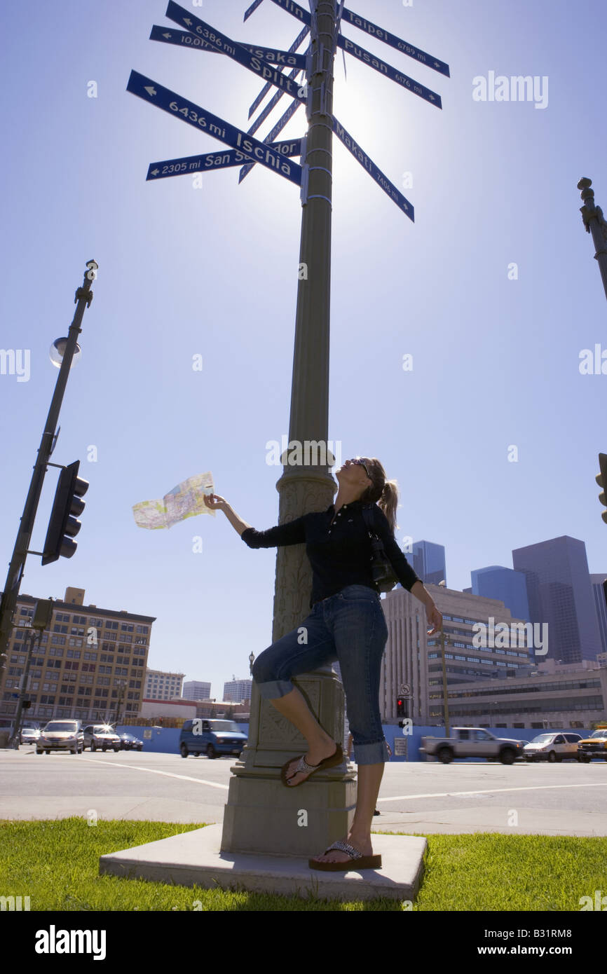 Woman reading map underneath sign Stock Photo - Alamy