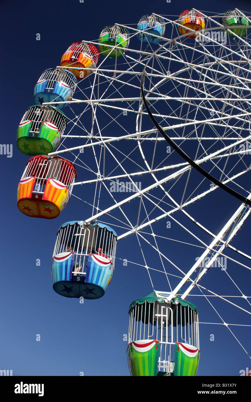 FERRIS WHEEL AT FAIRGROUND AGAINST BRIGHT BLUE SKY VERTICAL BDA11258 ...
