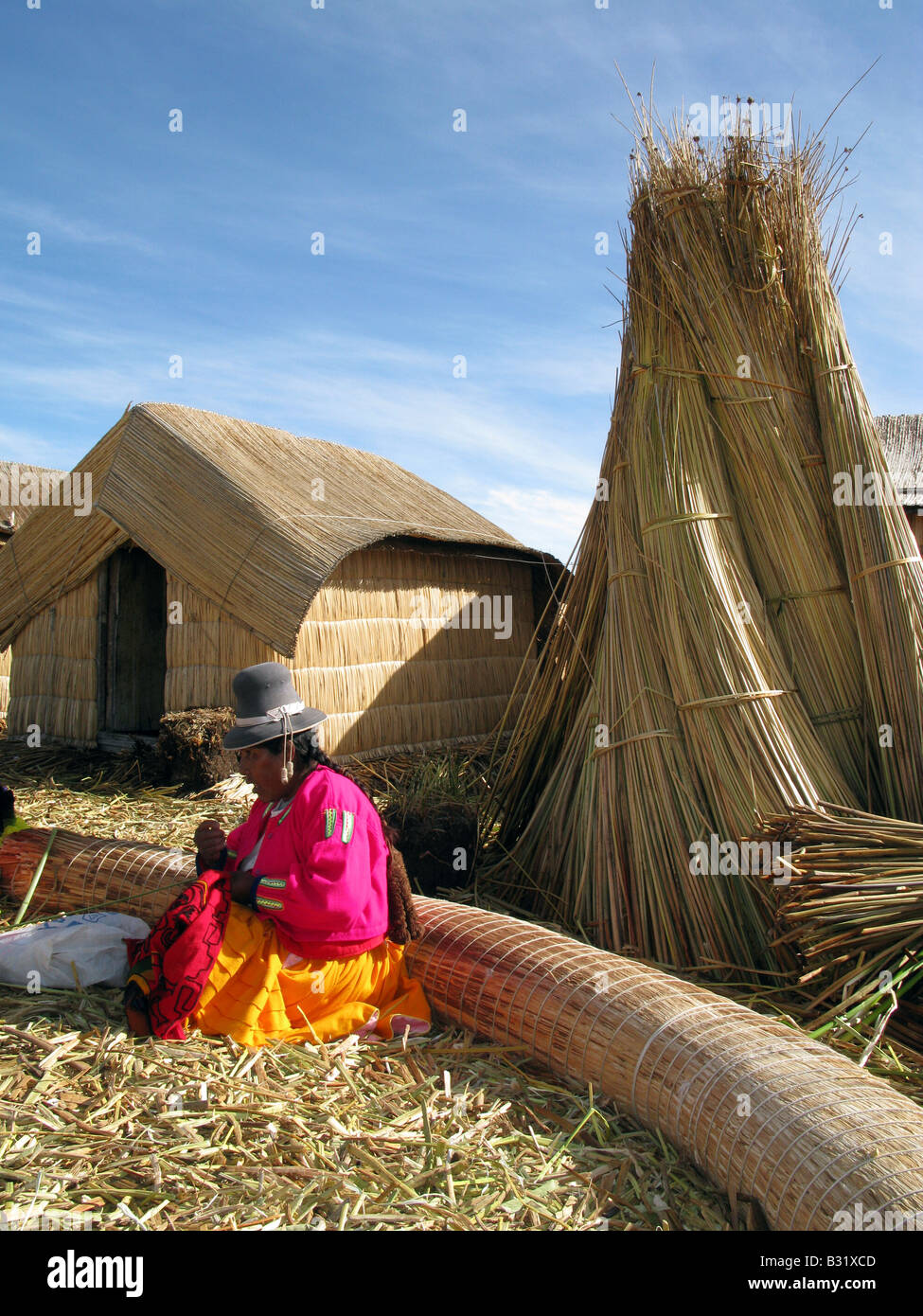 A Uros women weaving while living on self-fashioned floating reed ...