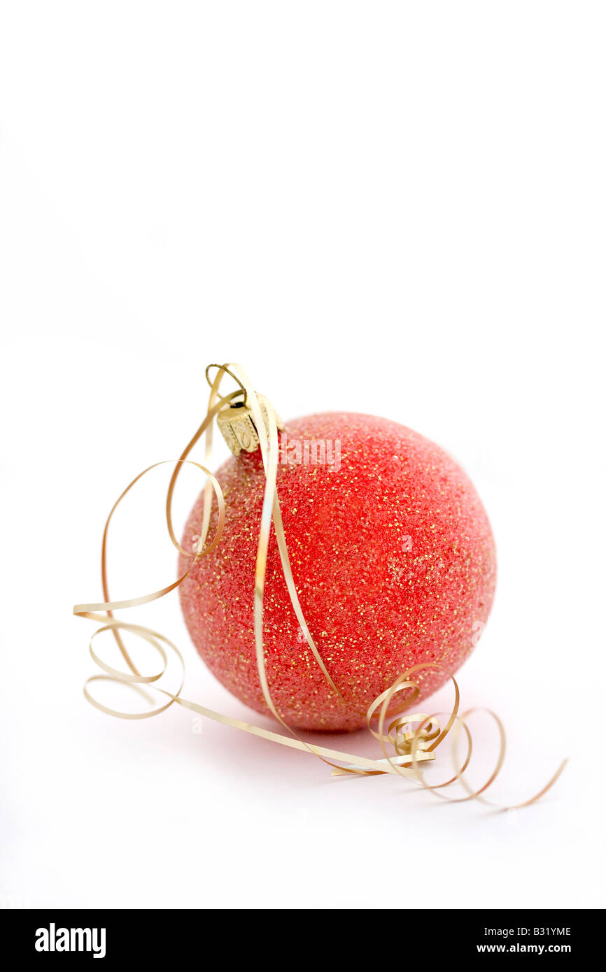 Single red frosted bauble with gold ribbon on a white background Stock ...