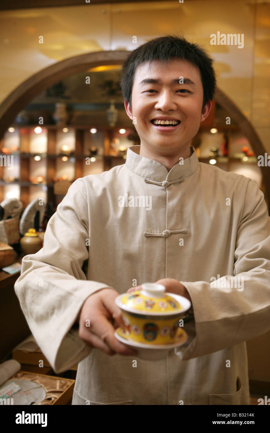 Chinese Young Man Holding Tea in Hand Stock Photo - Alamy