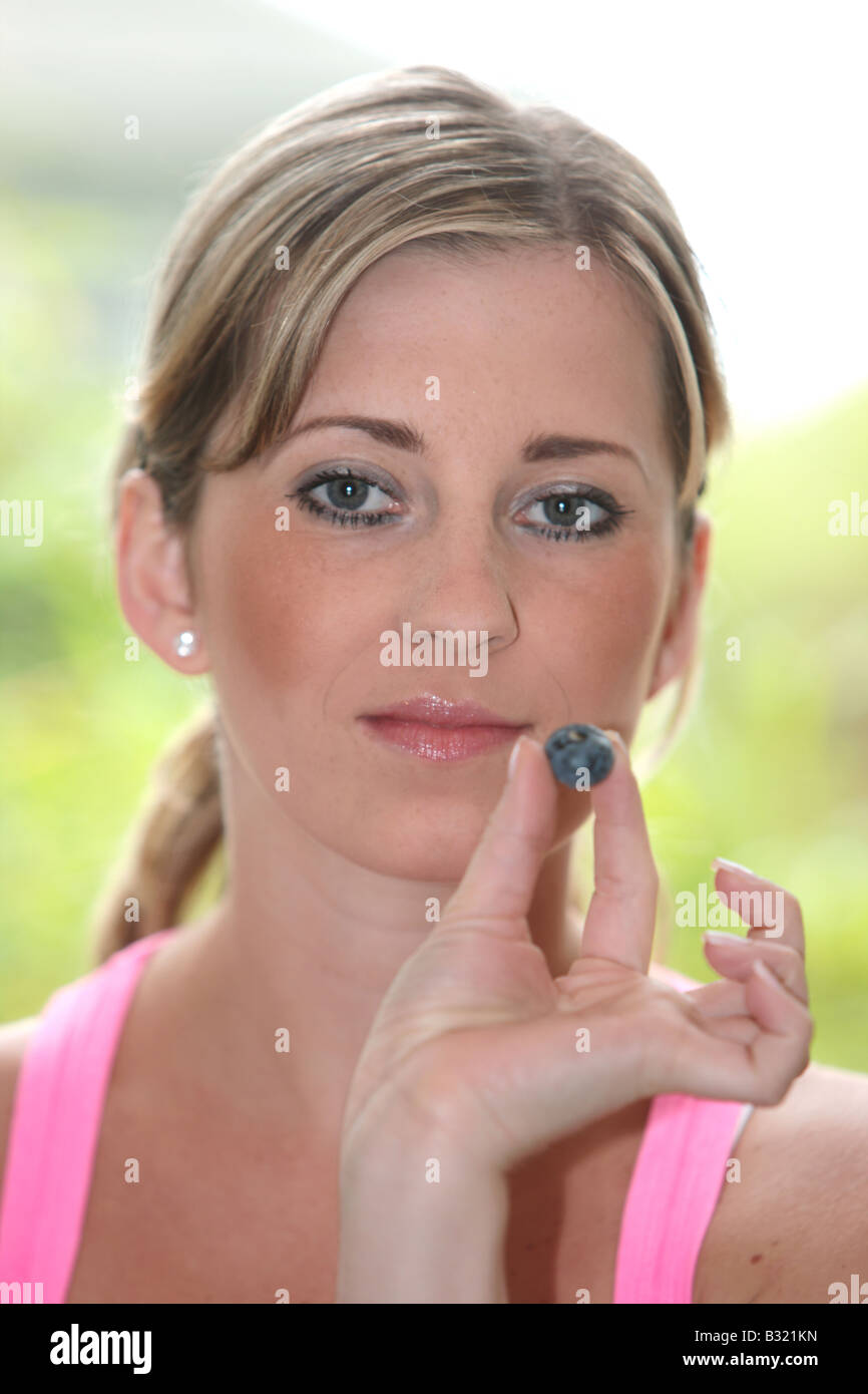 Young woman eating blueberry model hi-res stock photography and images ...