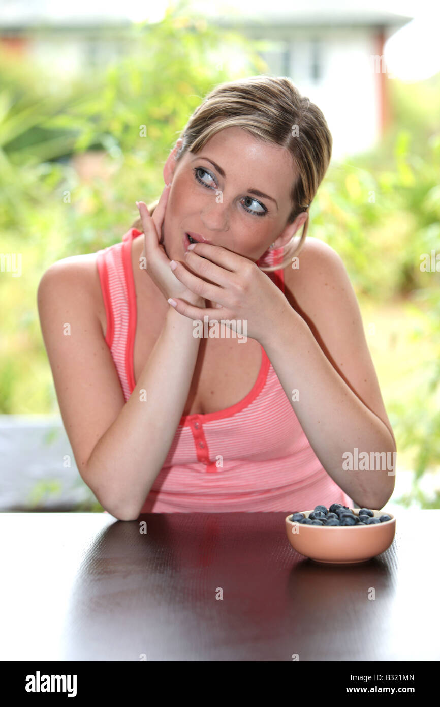 Young Woman Eating Blueberries Model Released Stock Photo - Alamy