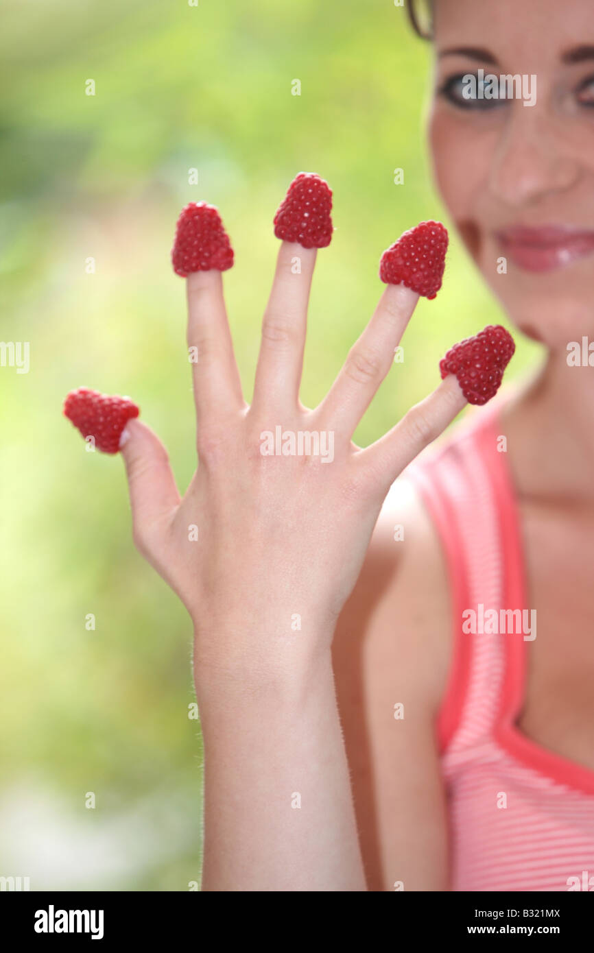 Young Woman with Raspberries on her Fingers Model Released Stock Photo ...