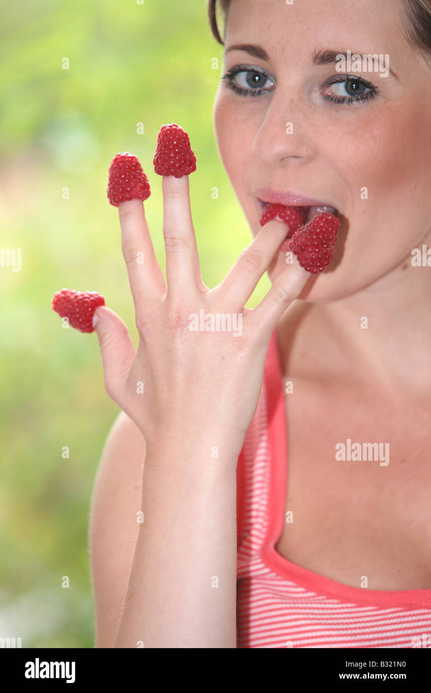 Young Woman Eating Raspberries Model Released Stock Photo - Alamy