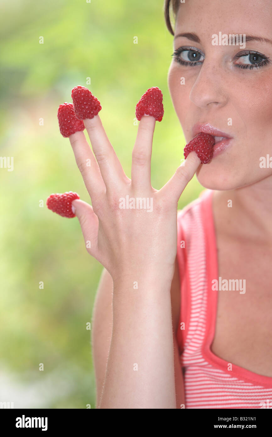 Young Woman Eating Raspberries Model Released Stock Photo - Alamy
