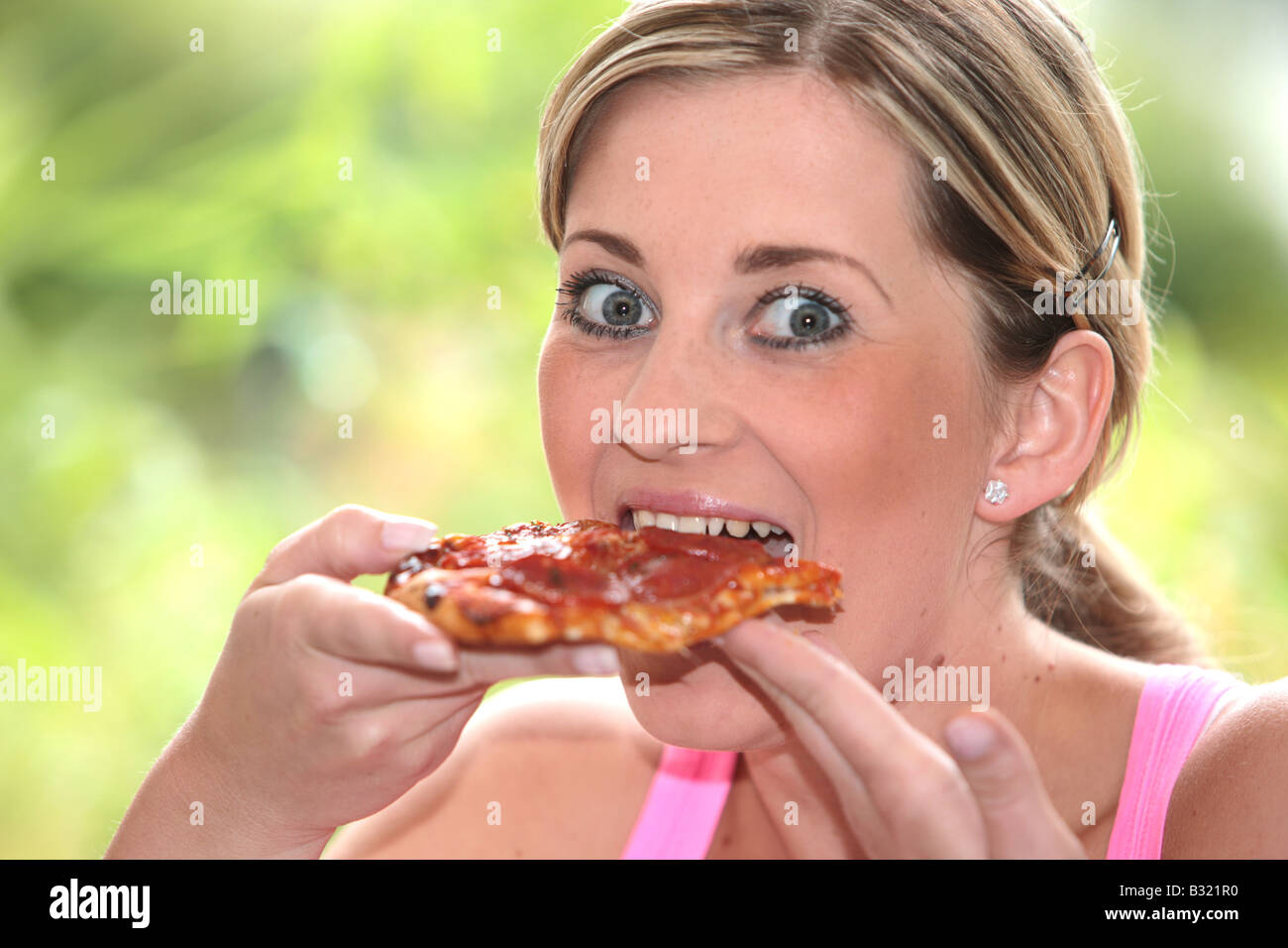 Young Woman Eating Pepperoni Pizza Model Released Stock Photo - Alamy