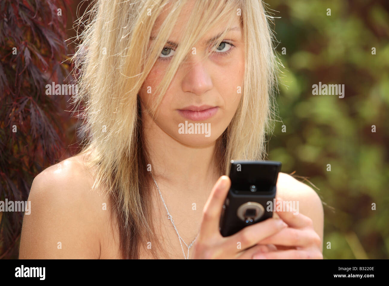 Young Woman Texting on Mobile Phone Model Released Stock Photo - Alamy