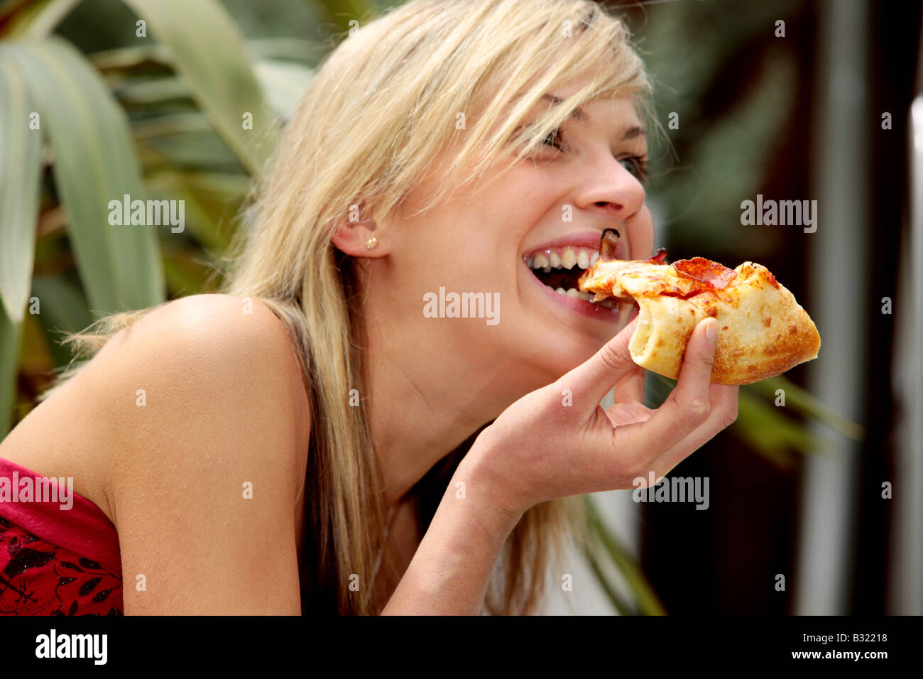 Young woman eating pizza model hi-res stock photography and images - Alamy