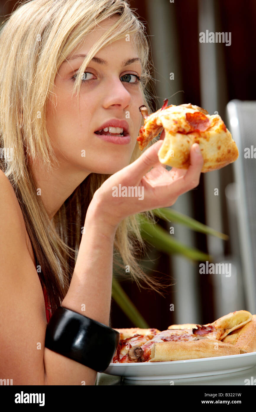 Young Woman Eating Pizza Model Released Stock Photo - Alamy
