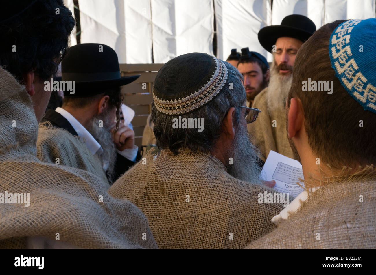 Israel jerusalem Western Wall group of people wearing jute bag on Tisha ...