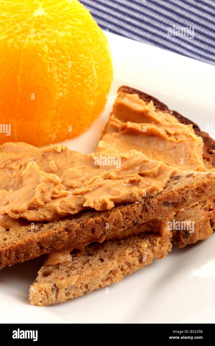 Rye Toast with Peanut Butter and an Orange Stock Photo - Alamy