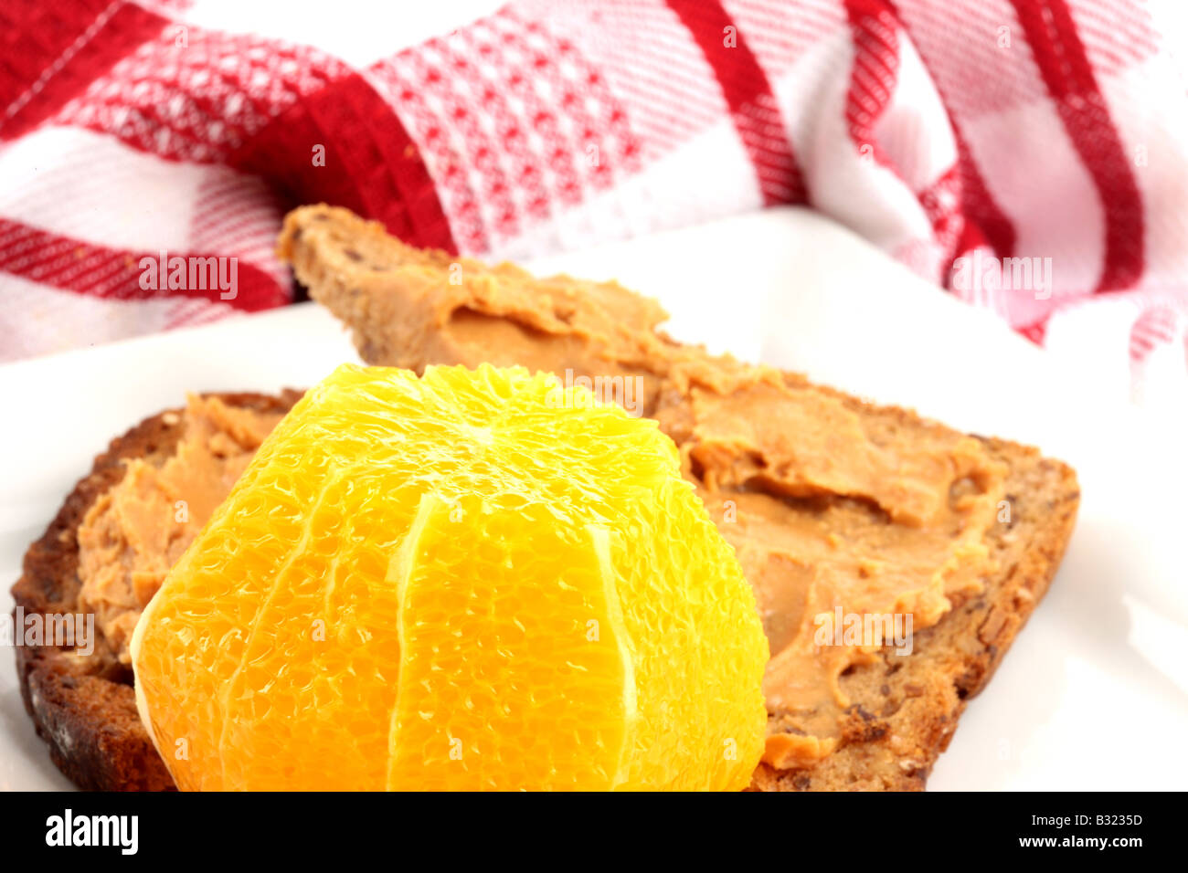 Rye Toast with Peanut Butter and an Orange Stock Photo - Alamy