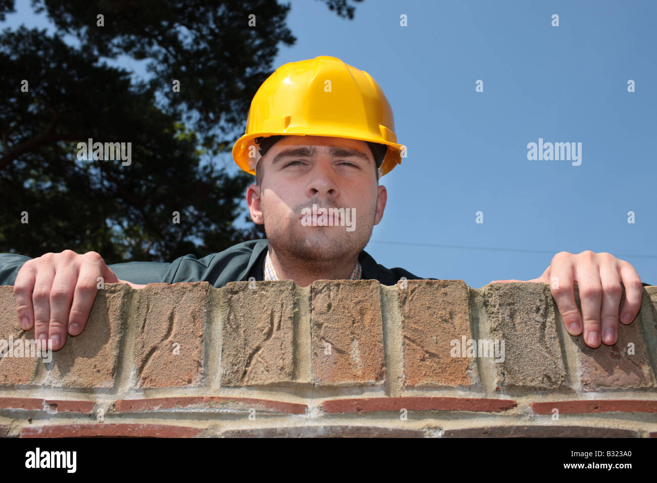 Builder Peering Over a Wall Model Released Stock Photo - Alamy