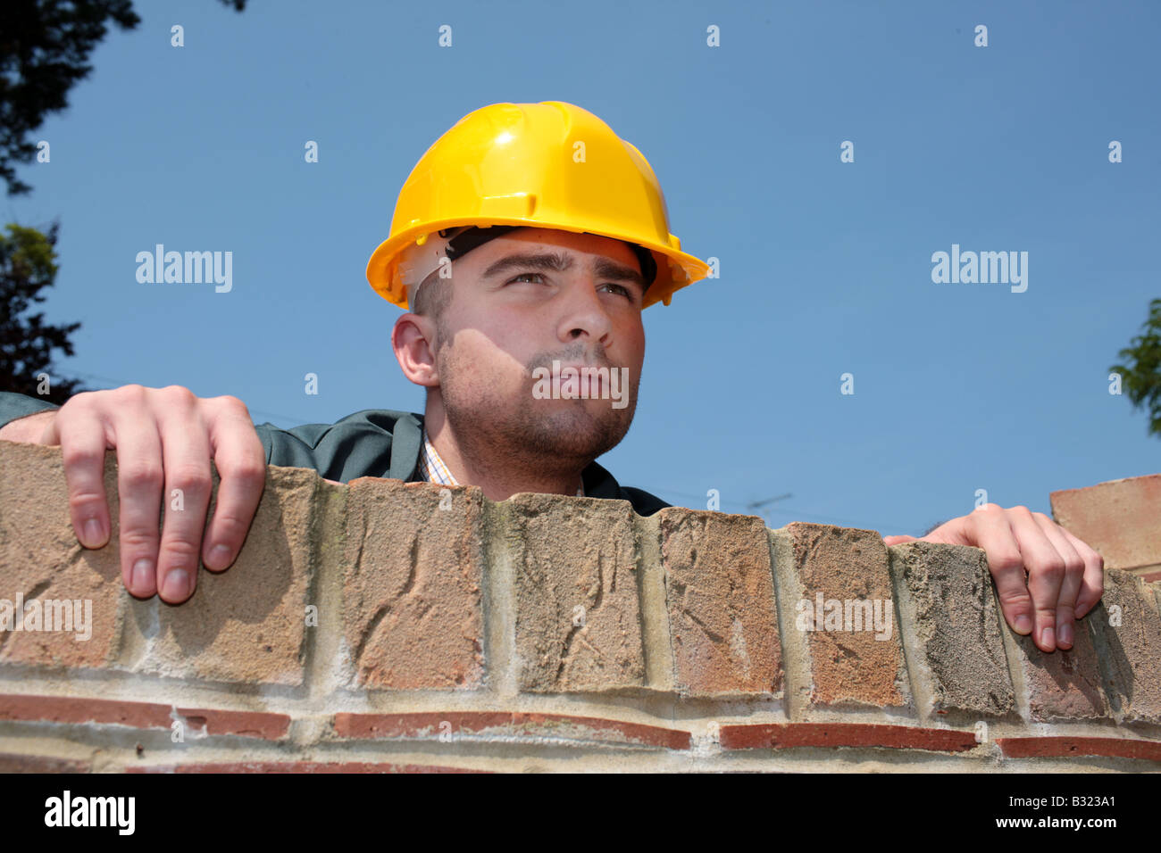 Builder Peering Over a Wall Model Released Stock Photo - Alamy