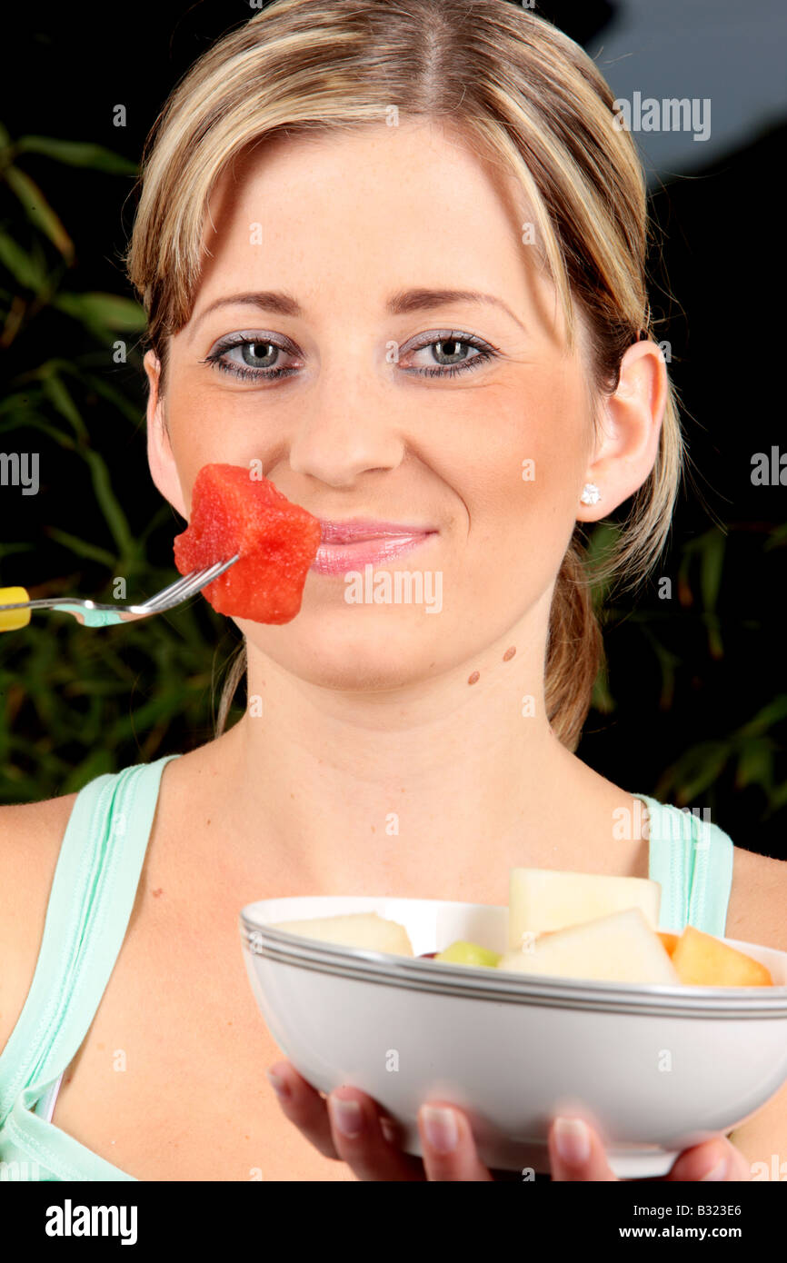 Young Woman Eating Fruit Salad Model Released Stock Photo - Alamy