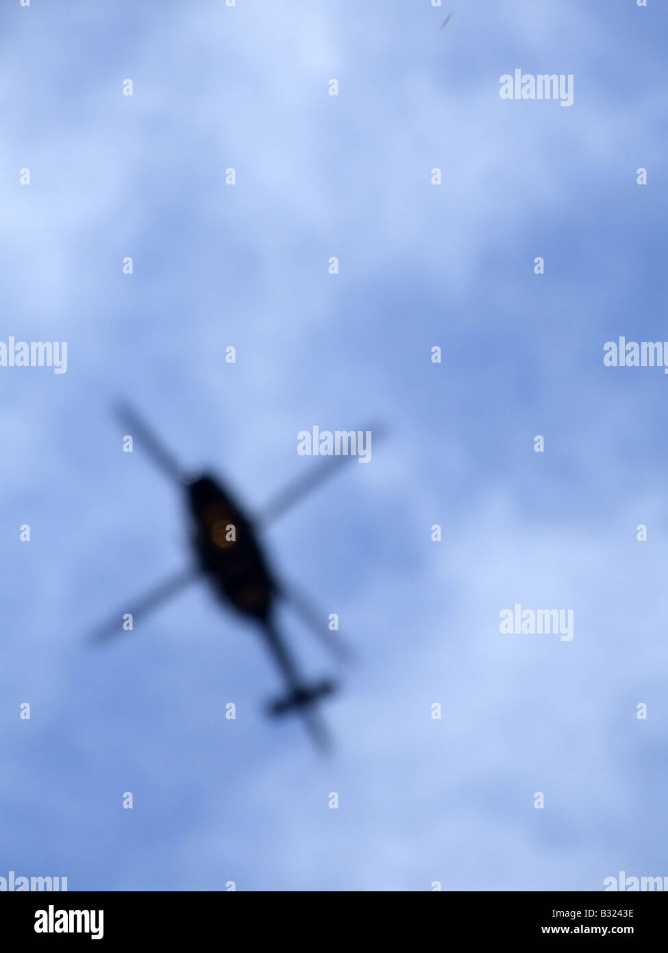 one helicoper flying overhead in blue sky Stock Photo - Alamy