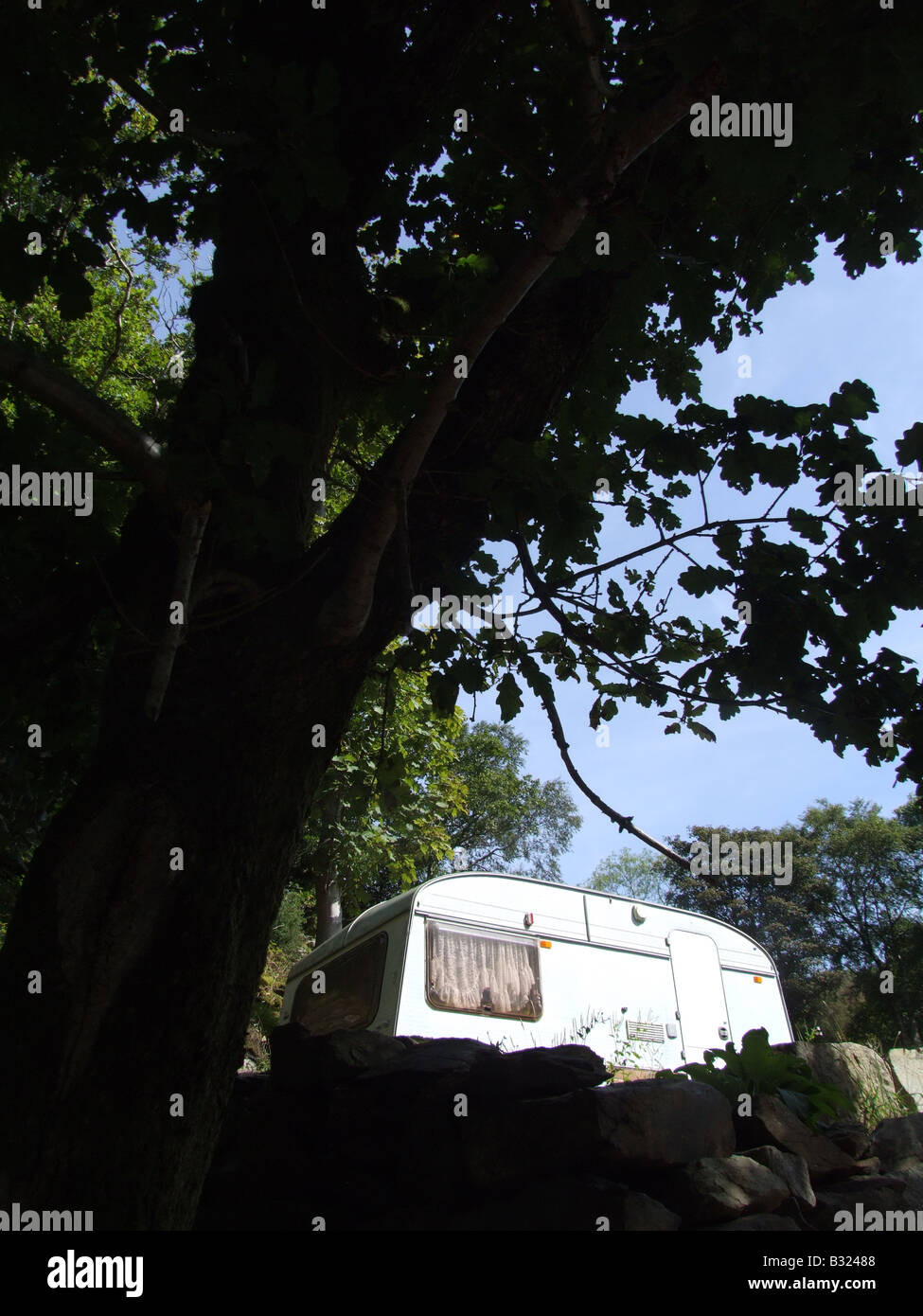 one small white caravan in field in countryside Stock Photo - Alamy