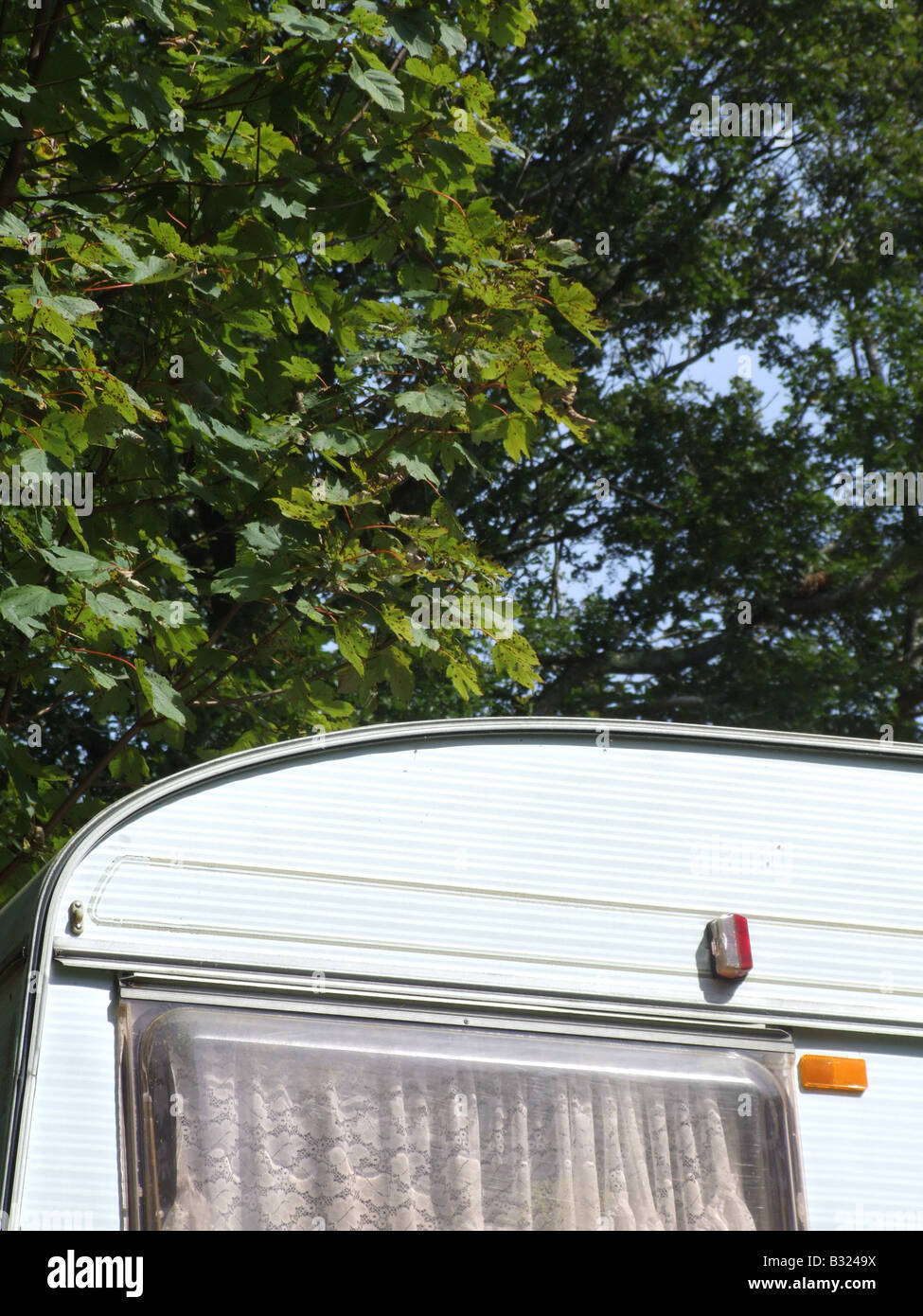 one small white caravan in field in countryside Stock Photo - Alamy