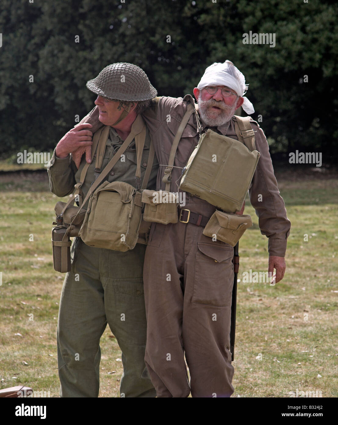 Two Home Guard soldiers one with head injury being supported by another ...