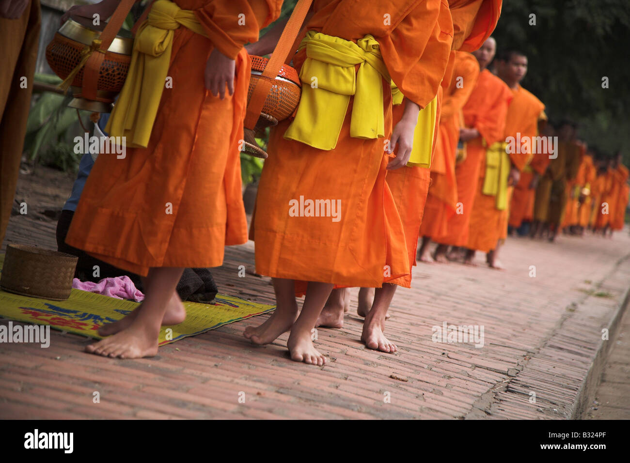 Lao monks receive morning alms in the World Heritage Site city of Luang ...