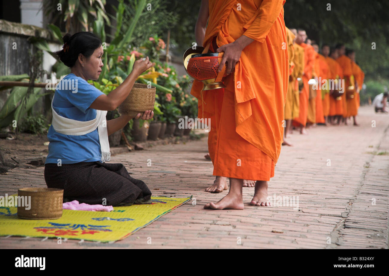 Lao monks receive morning alms in the World Heritage Site city of Luang ...