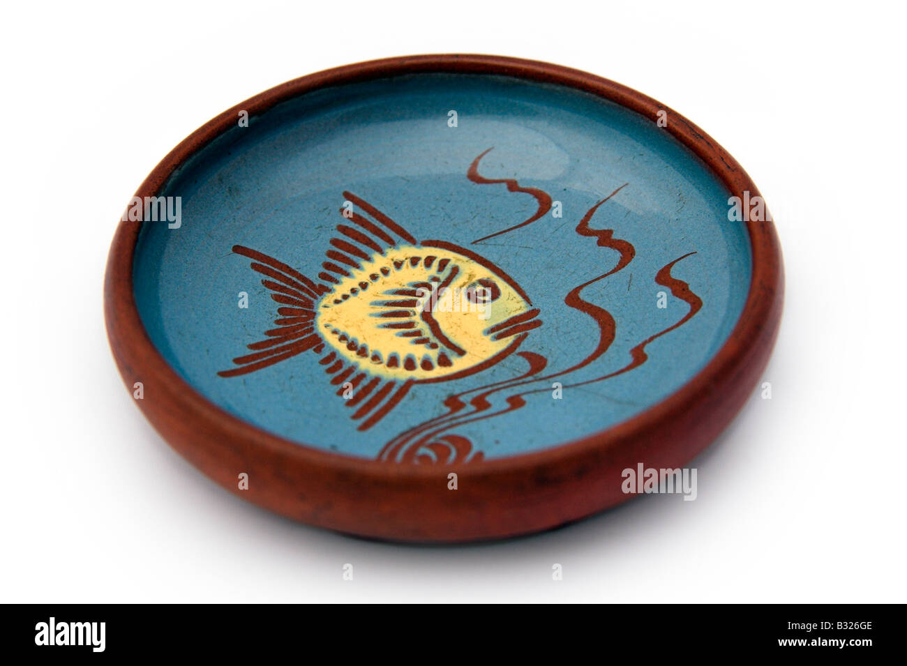 Small ceramic dish with fish design, white background Stock Photo - Alamy