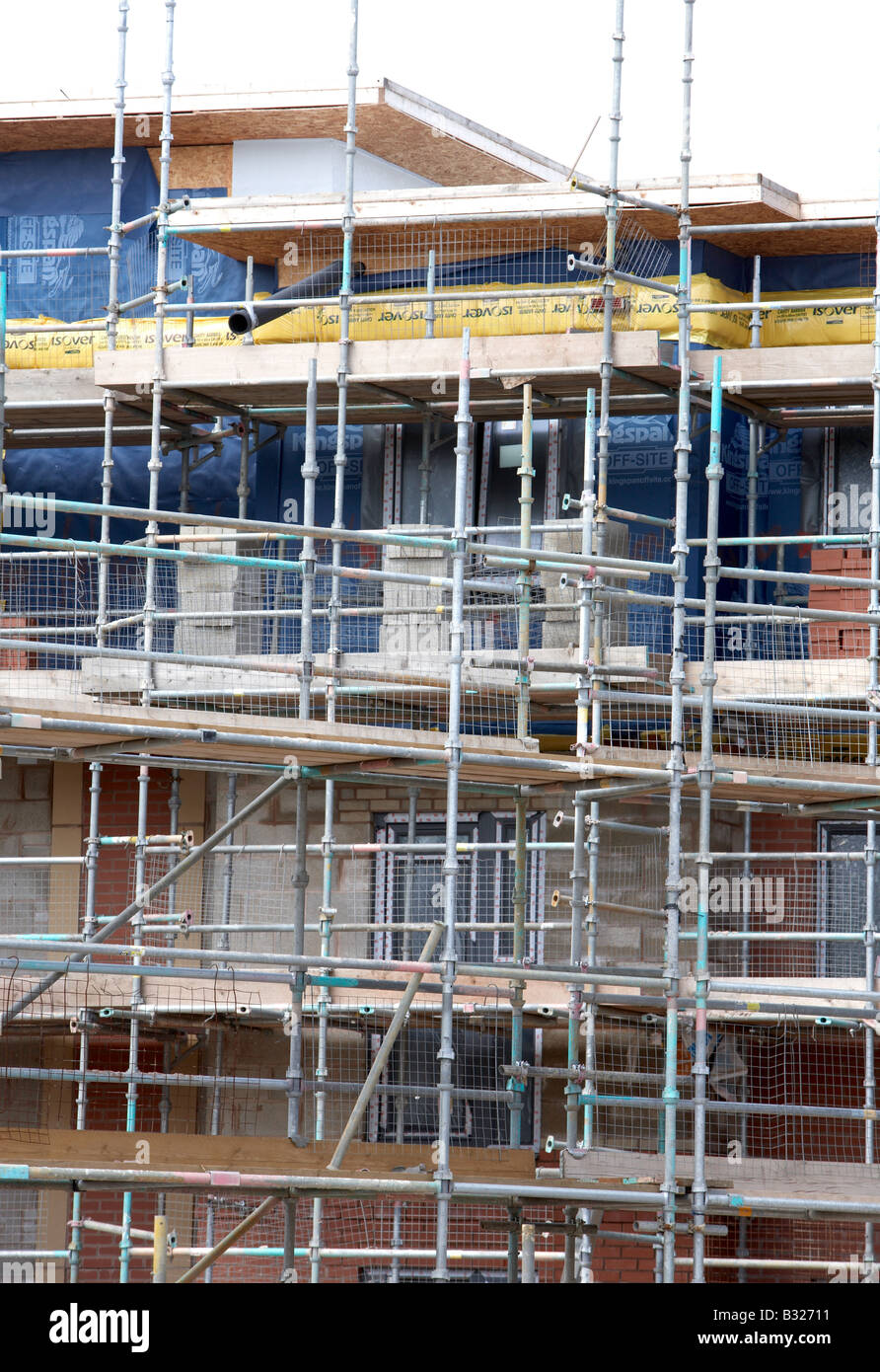 Scaffolding erected around a new development of housing on a building ...