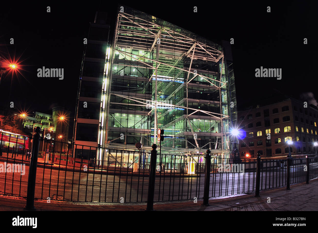 Glass and steel building near tower bridge at night Stock Photo - Alamy