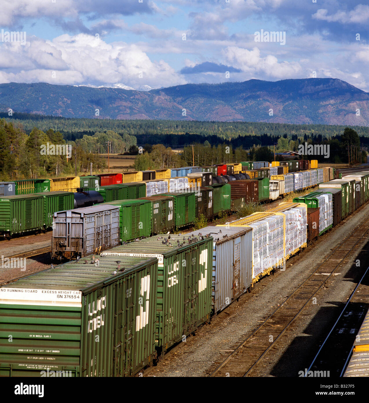 RAIL ROAD YARD IN WHITEFISH, MONTANA, ROCKY MOUNTAINS IN BACKGROUND ...