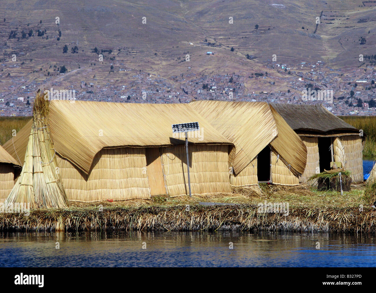 Solar panel outside a reed house Stock Photo - Alamy