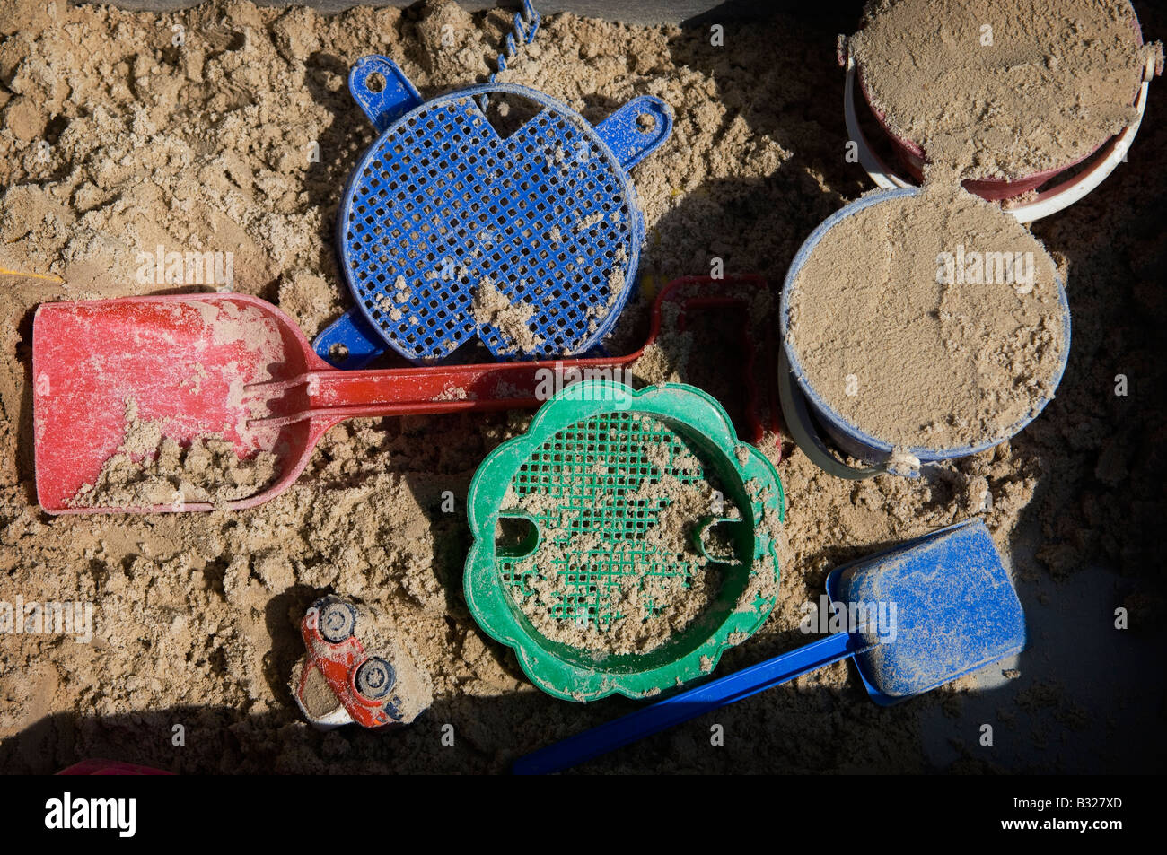 Buckets and spades in a sandpit Stock Photo - Alamy