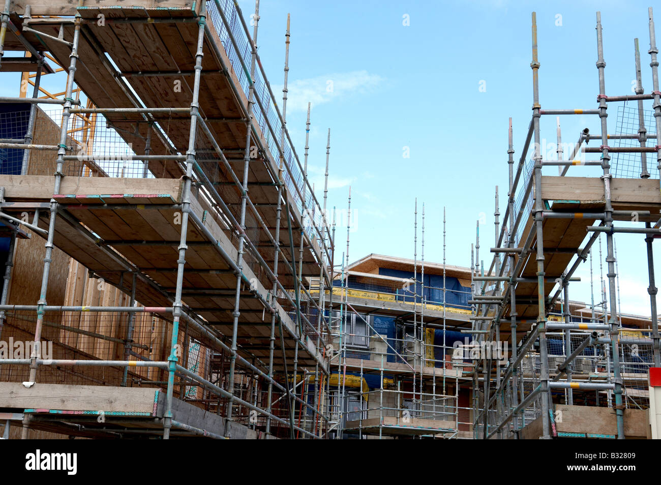 Scaffolding erected around a new development of housing on a building ...