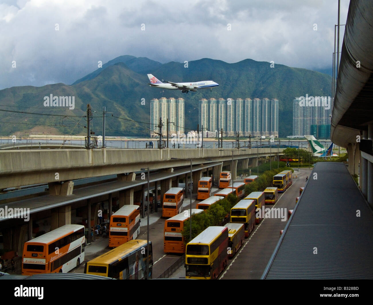 Plane coming in to land above bus station at Hong Kong International ...