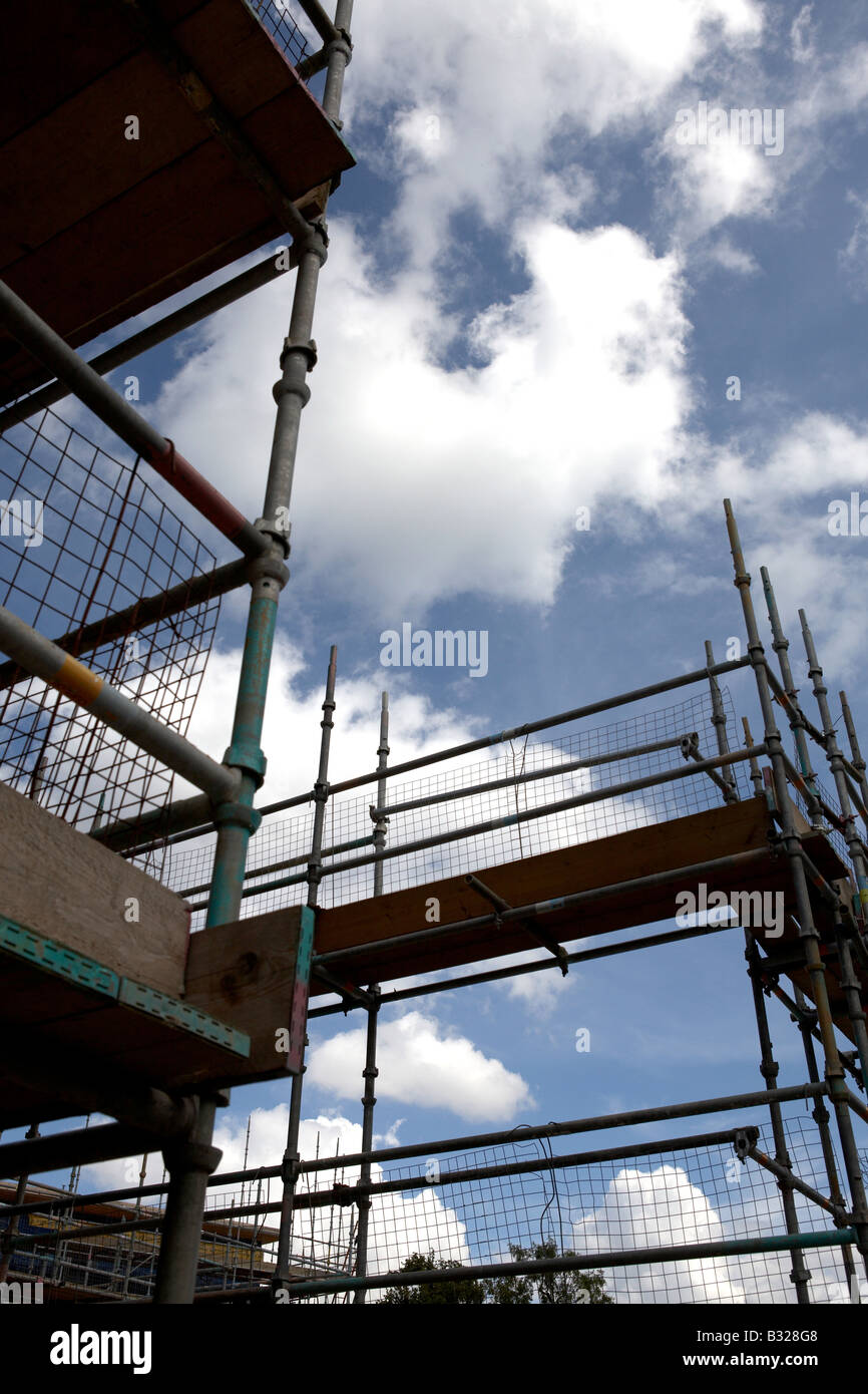 Scaffolding erected around a new development of housing on a building ...