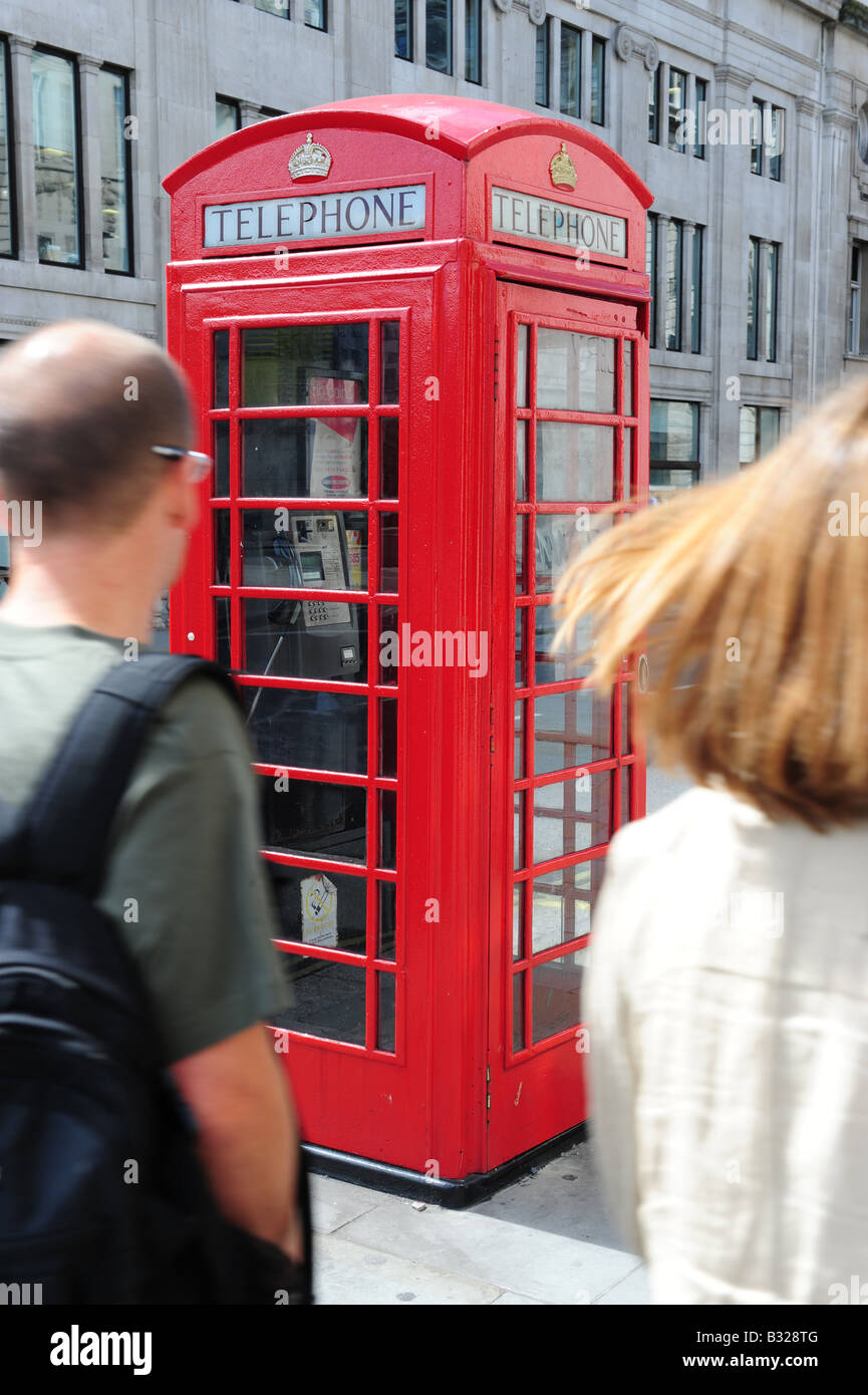 People walking past a British telephone box in London Stock Photo - Alamy